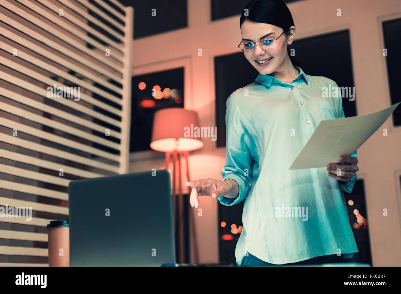 Pretty woman pointing at screen of a laptop Stock Photo - Alamy