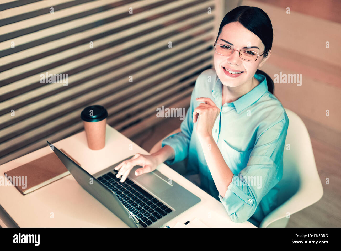 Happy employee finishing her work Stock Photo - Alamy