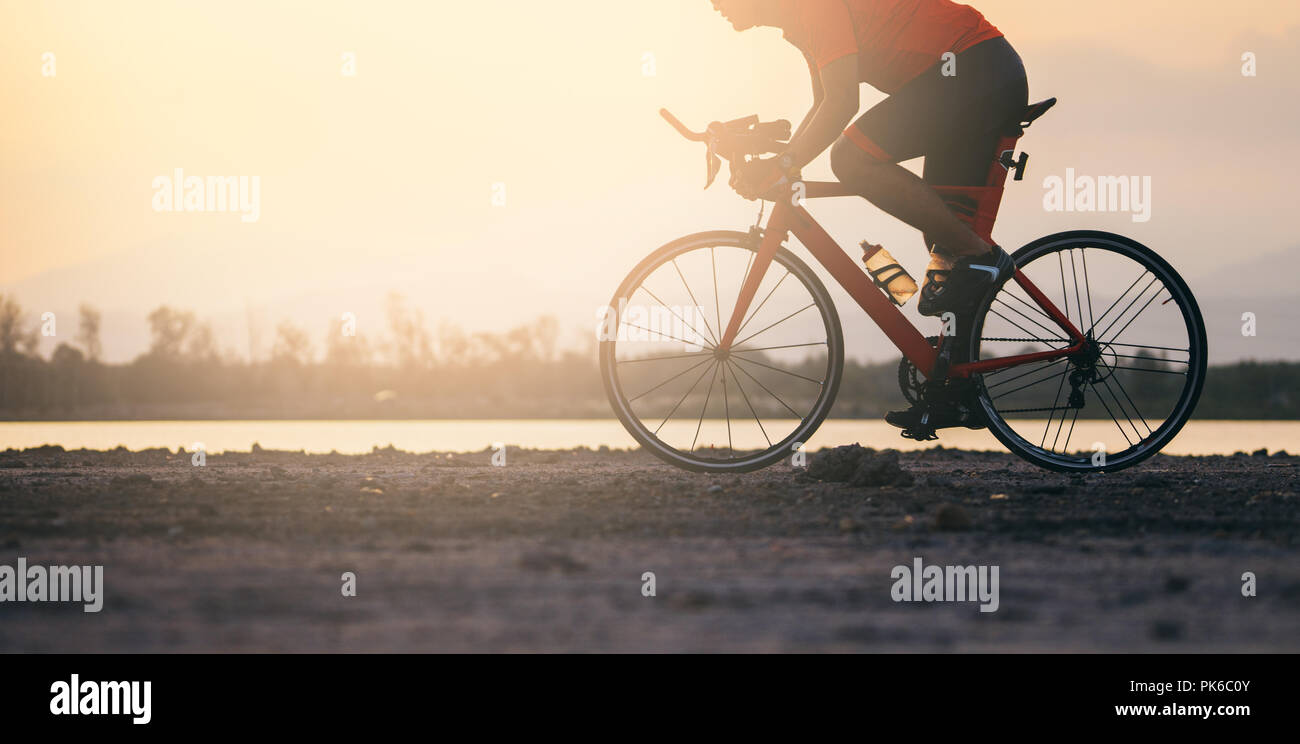 A cyclist riding a road bike on road in the moring Stock Photo - Alamy