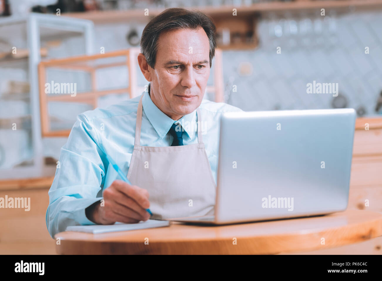 Attentive waiter staring at computer Stock Photo - Alamy
