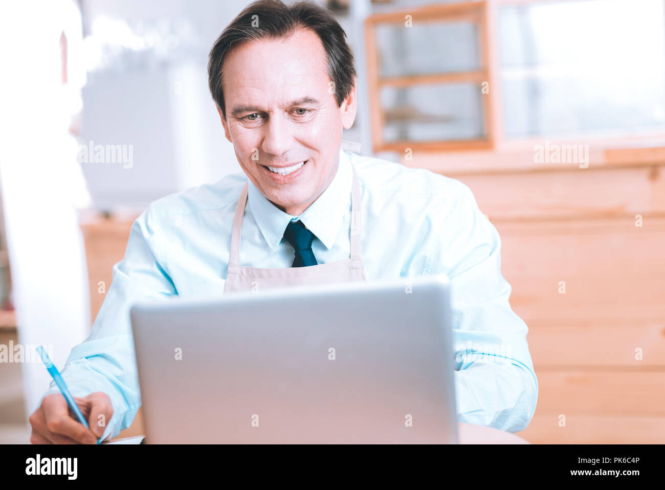 Delighted male person looking at screen of his computer Stock Photo - Alamy