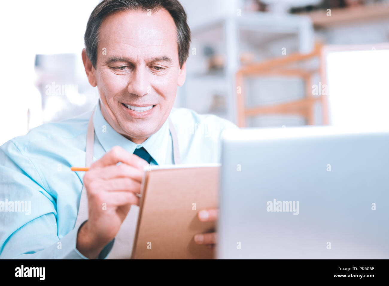 Pleased waiter taking order for table Stock Photo - Alamy