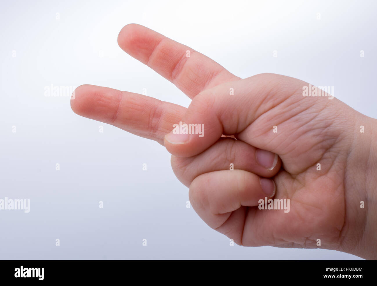Kid's hand making a number two gesture Stock Photo - Alamy