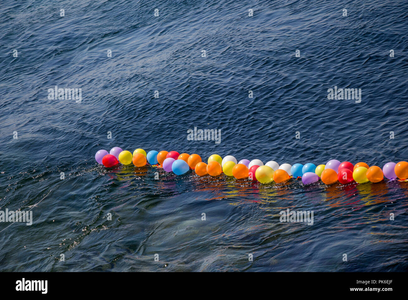 Balloon on a string on water for shooting game Stock Photo - Alamy