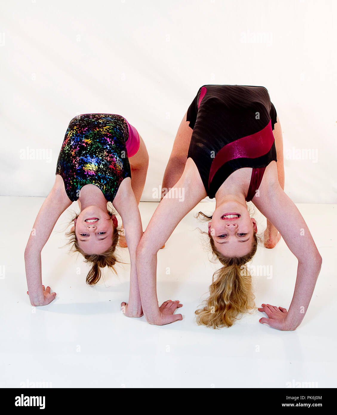 Two beautiful young girls having fun working on their gymnastics. Some ...