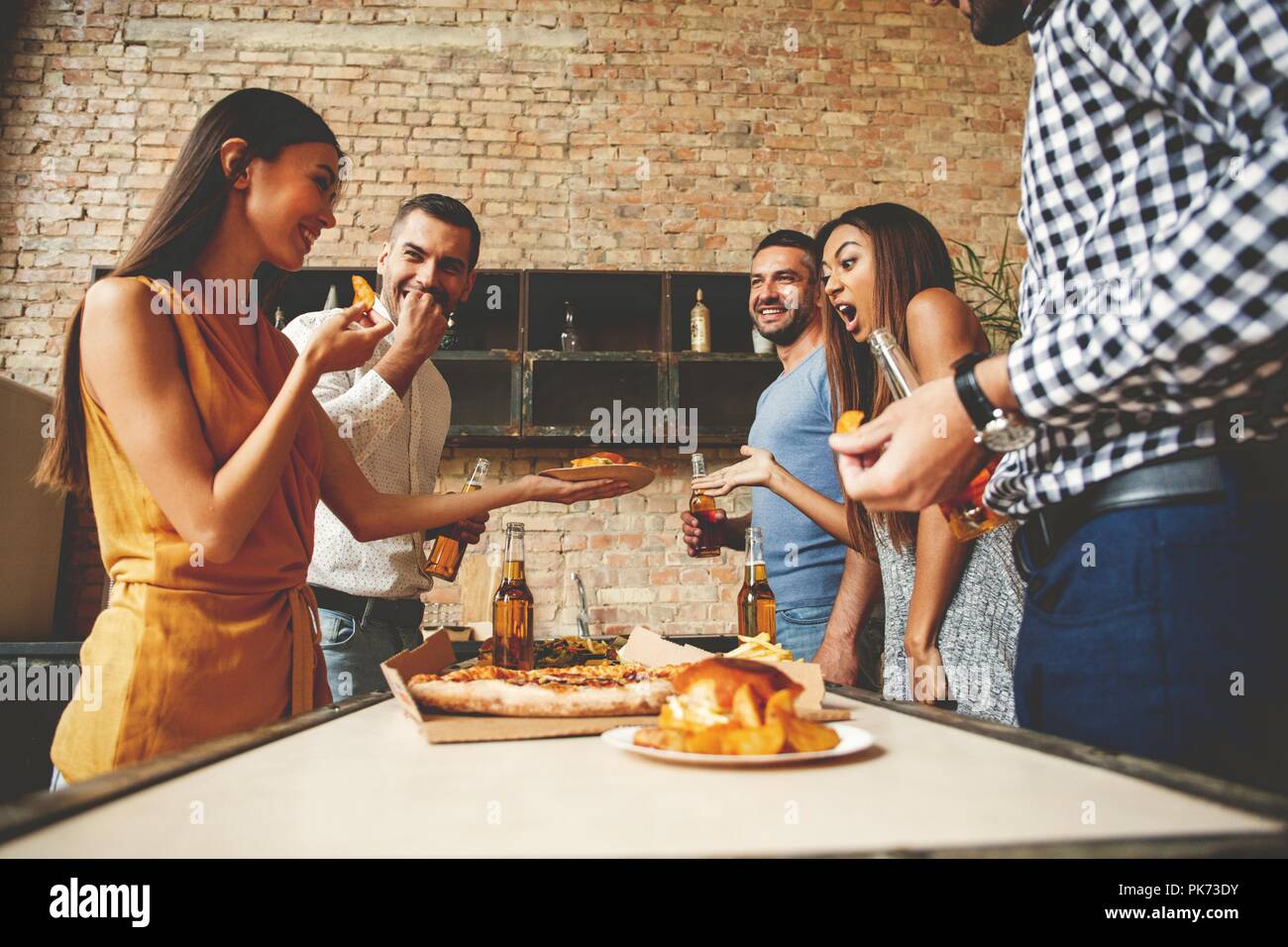 Home party. Full length of cheerful young people enjoying home party ...