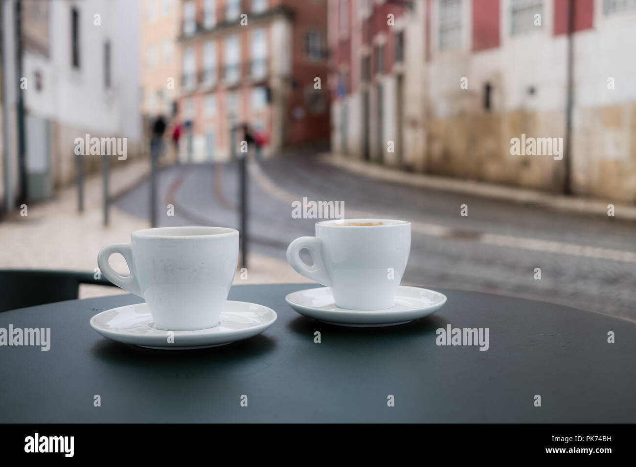 Coffee cup on a table of typical European outdoor cafe Stock Photo - Alamy