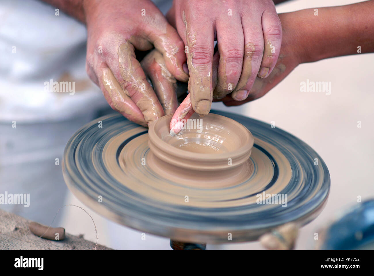 Hands working on pottery wheel Stock Photo - Alamy