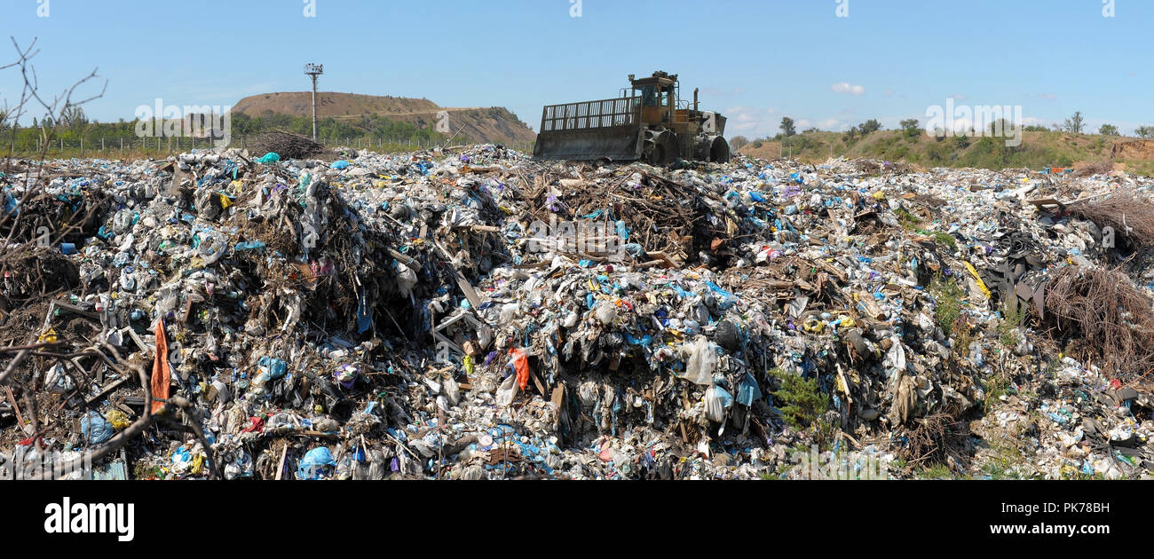 The bulldozer buries food and industrial wastes Stock Photo - Alamy