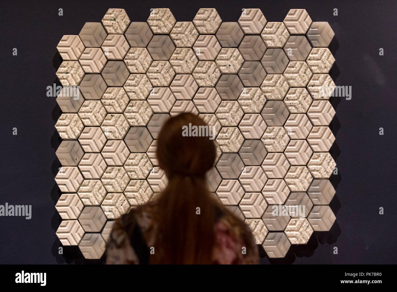 London, UK. 11 September 2018. A staff member views upcycled tiles made ...