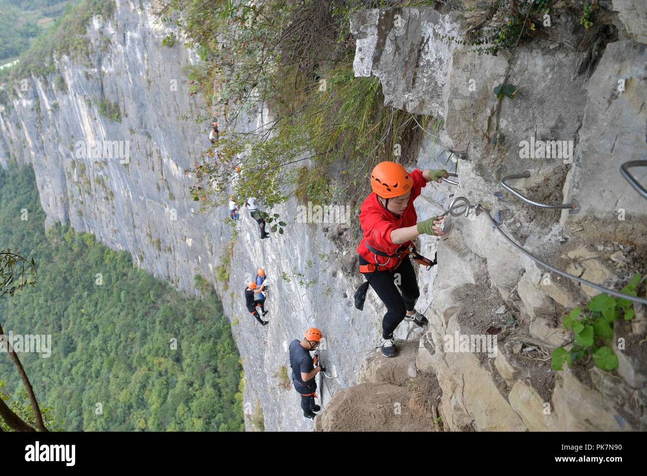 Enshi, China's Hubei Province. 11th Sep, 2018. Sports fans climb a ...