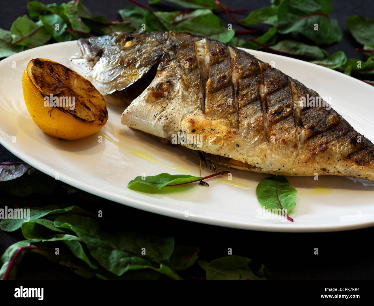 fried dorado stuffed with aromatic herbs Stock Photo - Alamy