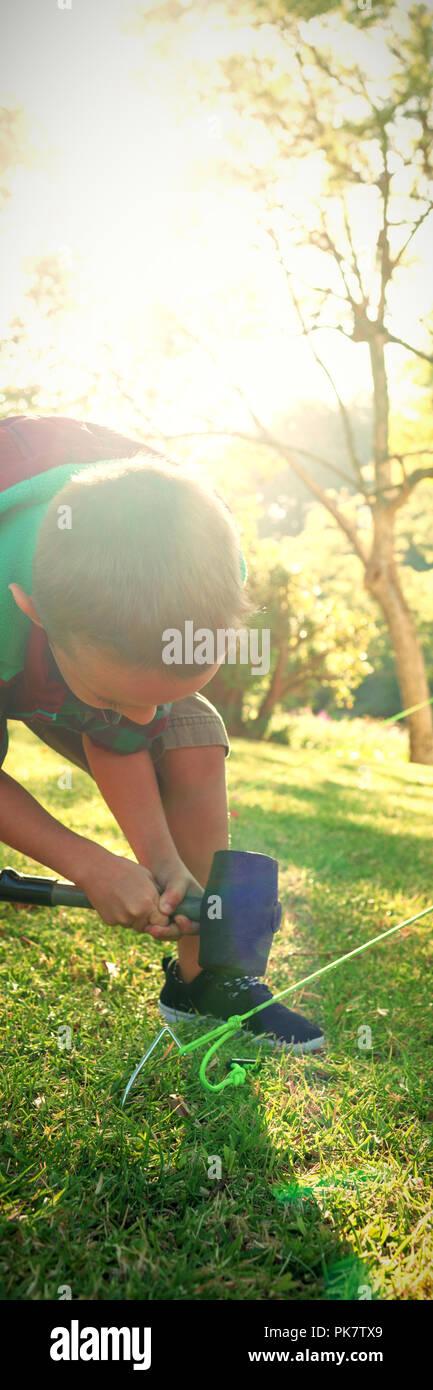 Boy setting up the tent at campsite Stock Photo - Alamy