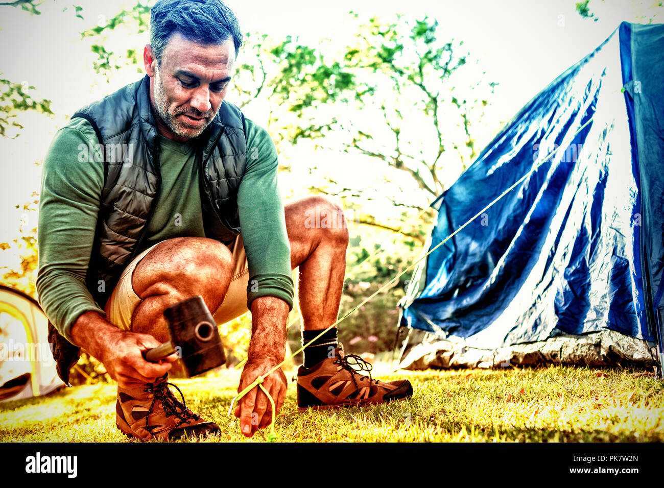 Man setting up the tent Stock Photo - Alamy