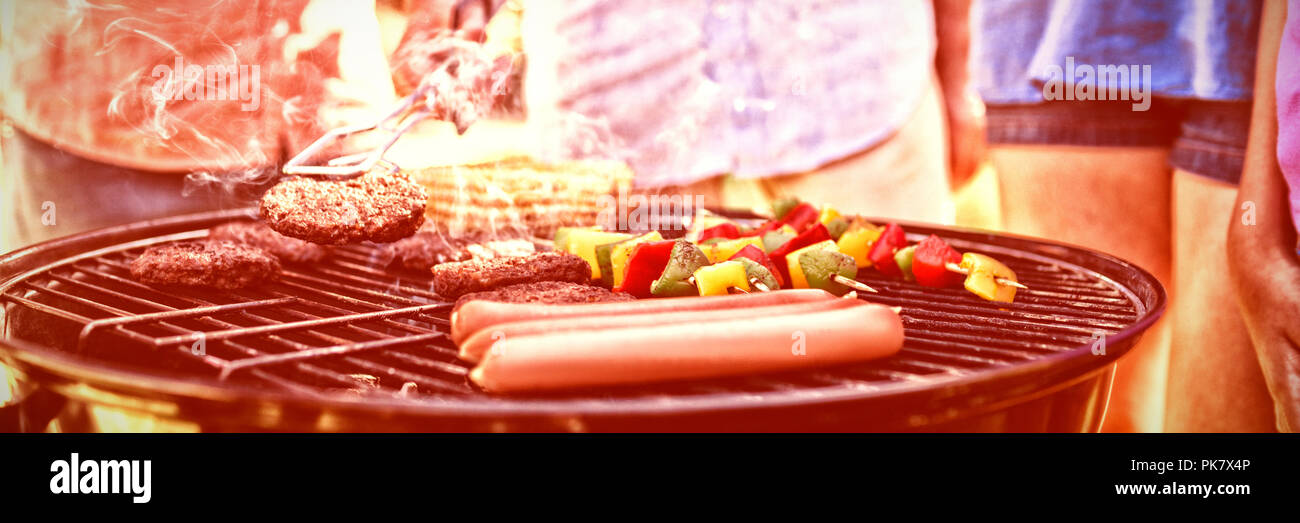 Family having a barbecue Stock Photo - Alamy
