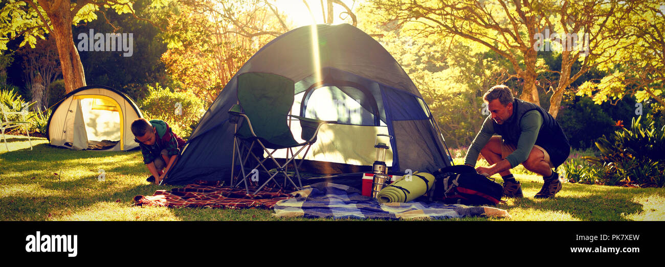 Boy setting up the tent at campsite Stock Photo - Alamy