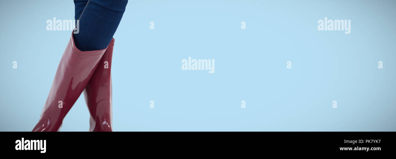 Composite image of woman in wellington boot standing with leg crossed ...