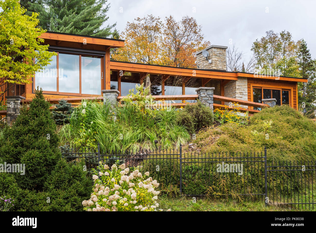 Rear view of luxurious stained cedar and timber wood home with ...