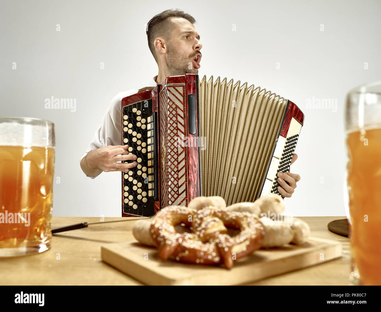 Man in traditional bavarian clothes playing accordion. Germany, Bavaria ...