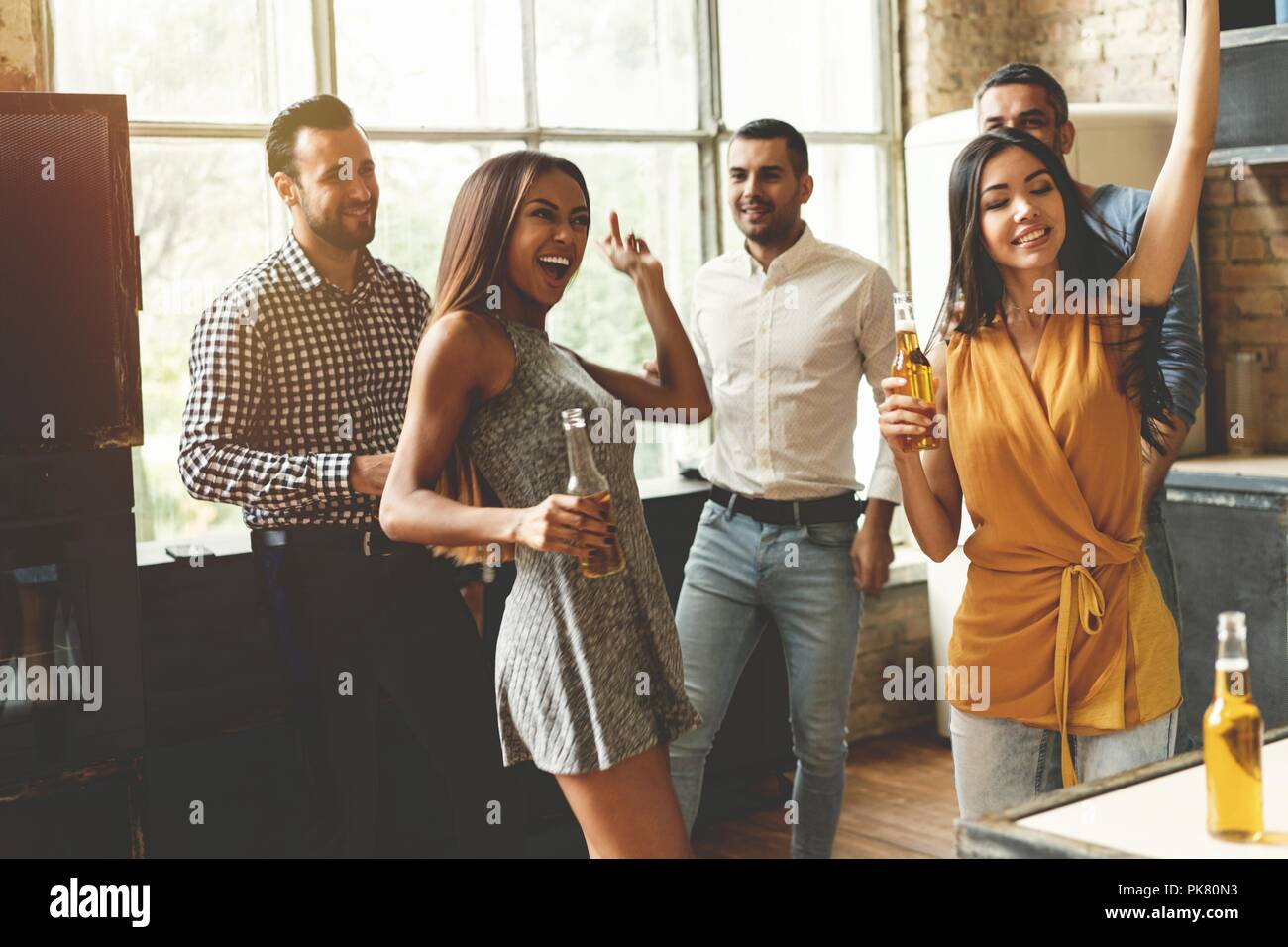 Enjoying party with best friends. Cheerful young people dancing and ...