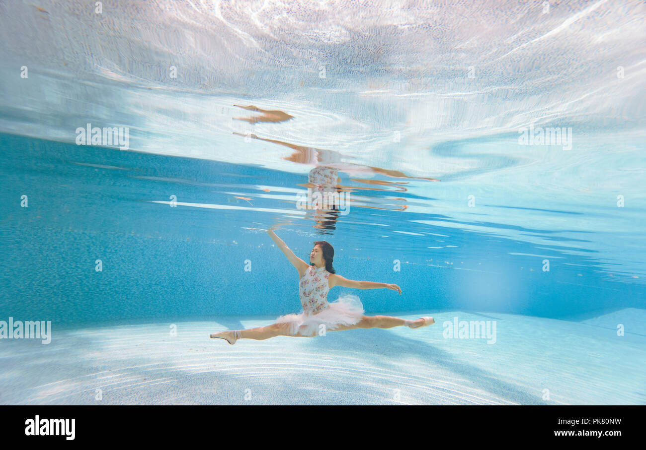 Japanese ballerina is dancing under water and making Grand Jete (twine ...