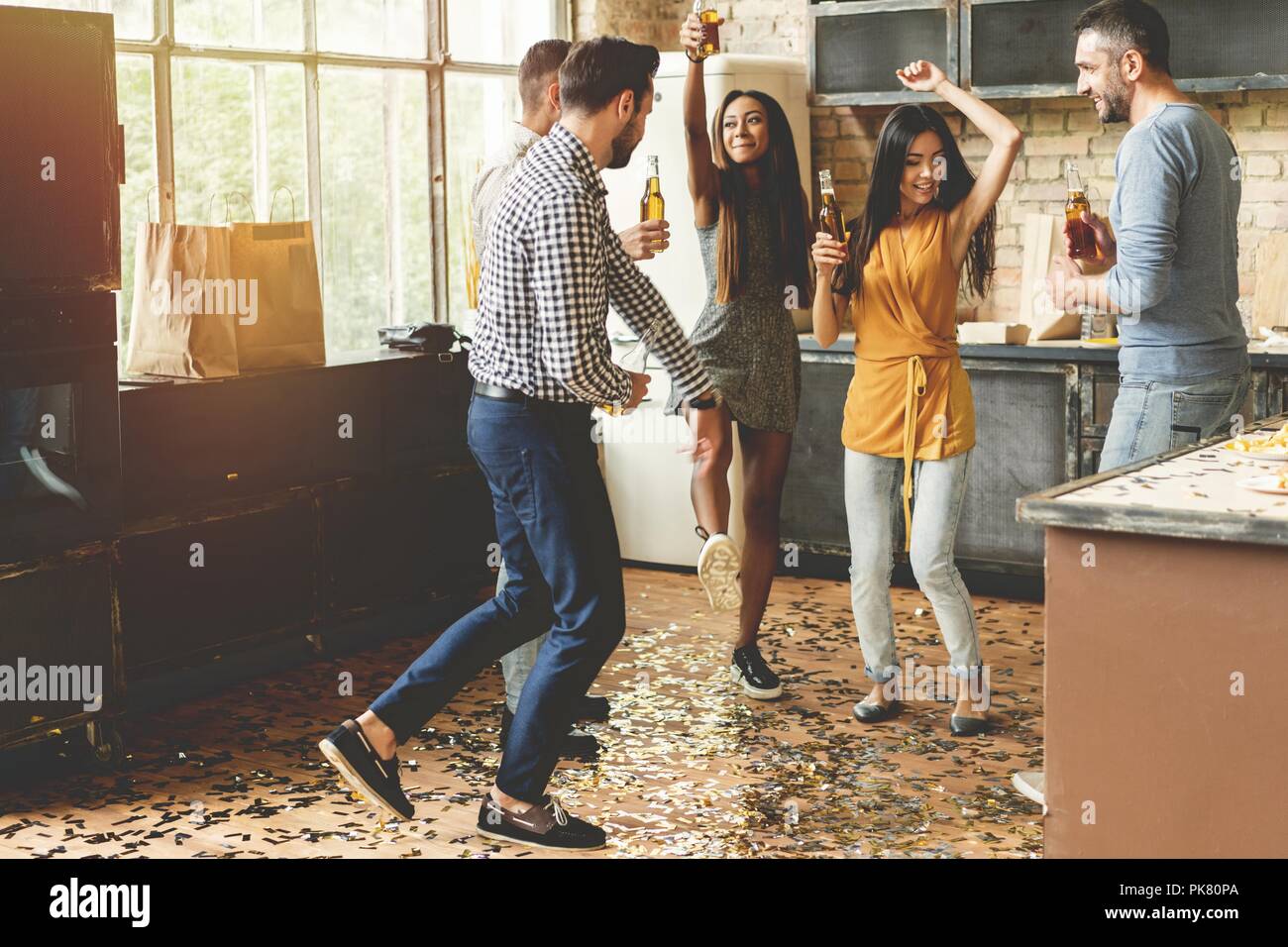 Enjoying party with best friends. Cheerful young people dancing and ...