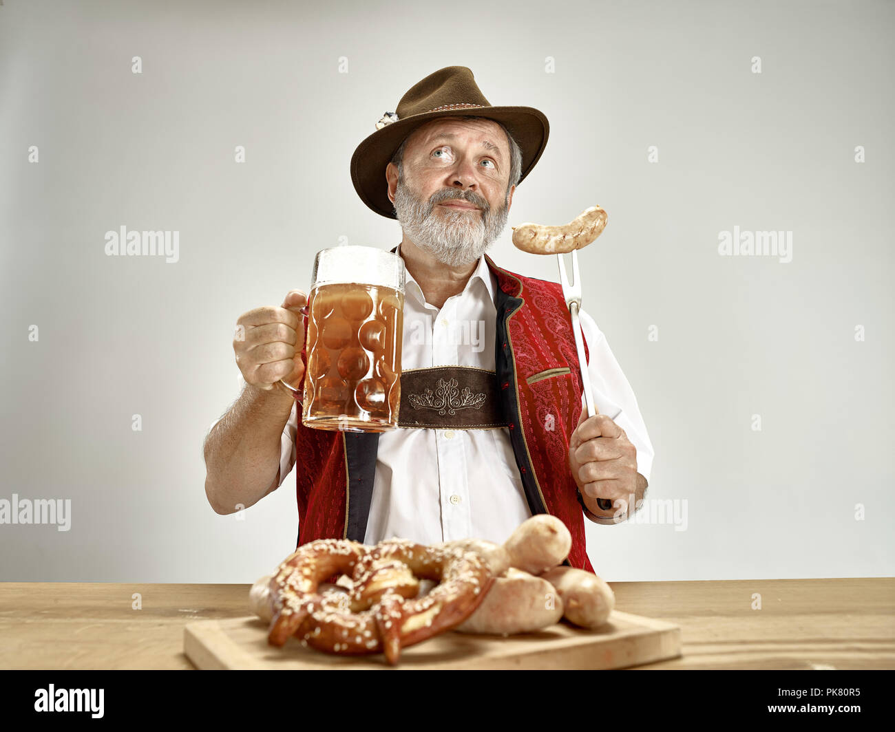 Germany, Bavaria, Upper Bavaria. The senior happy smiling man with beer ...