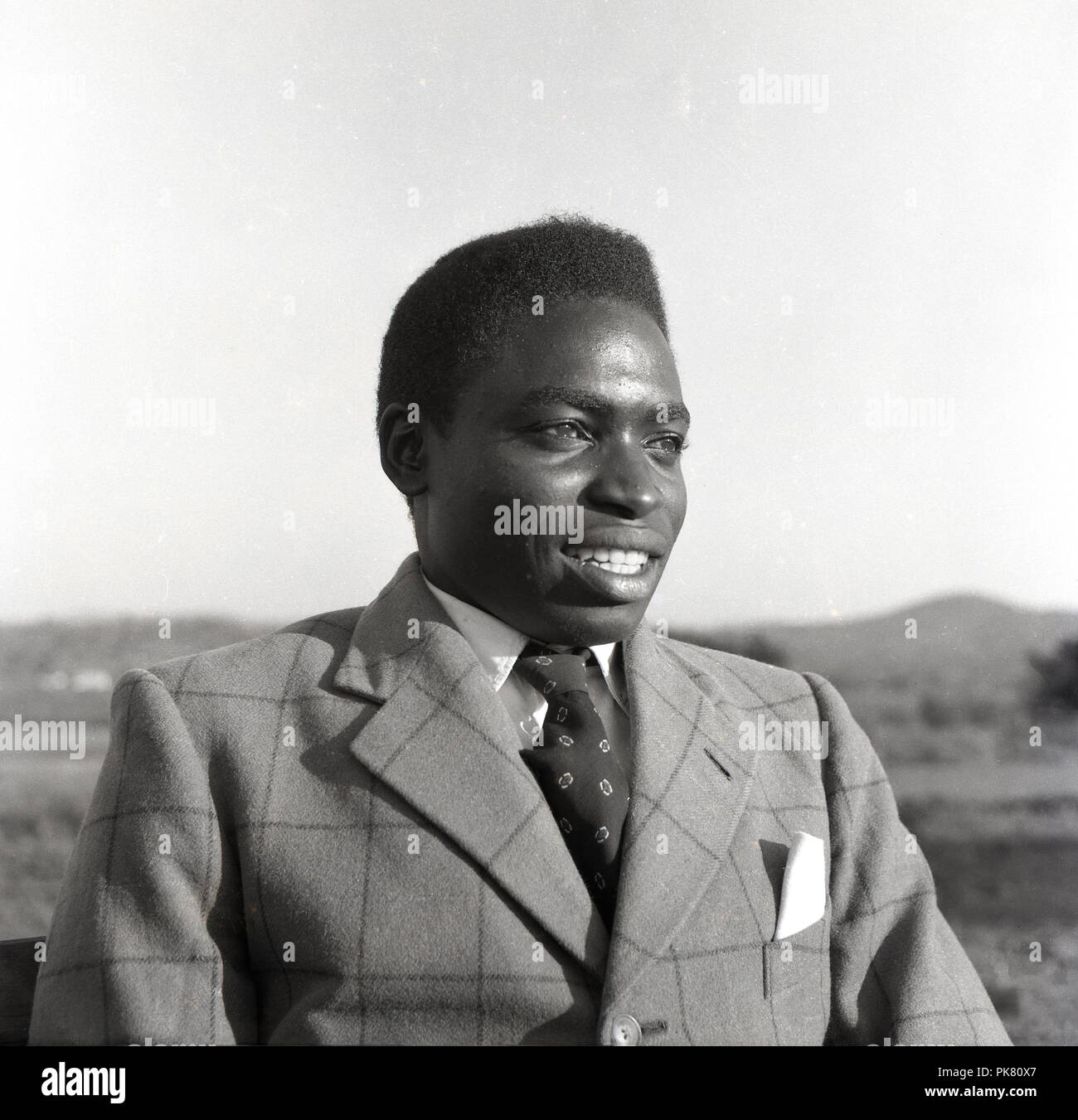 1950s, historical, a potrait of a well-dressed young Ugandan man ...