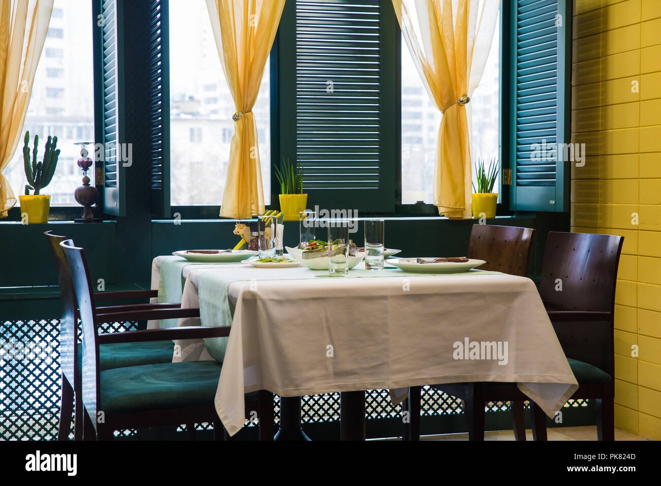 Cafe, table setting, yellow and green color - table by the window ...