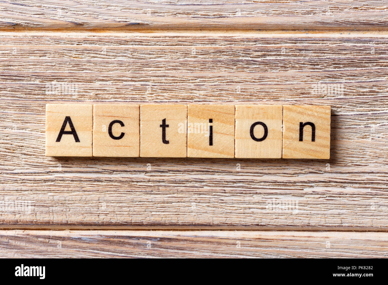 Action word written on wood block. Action text on table, concept Stock ...