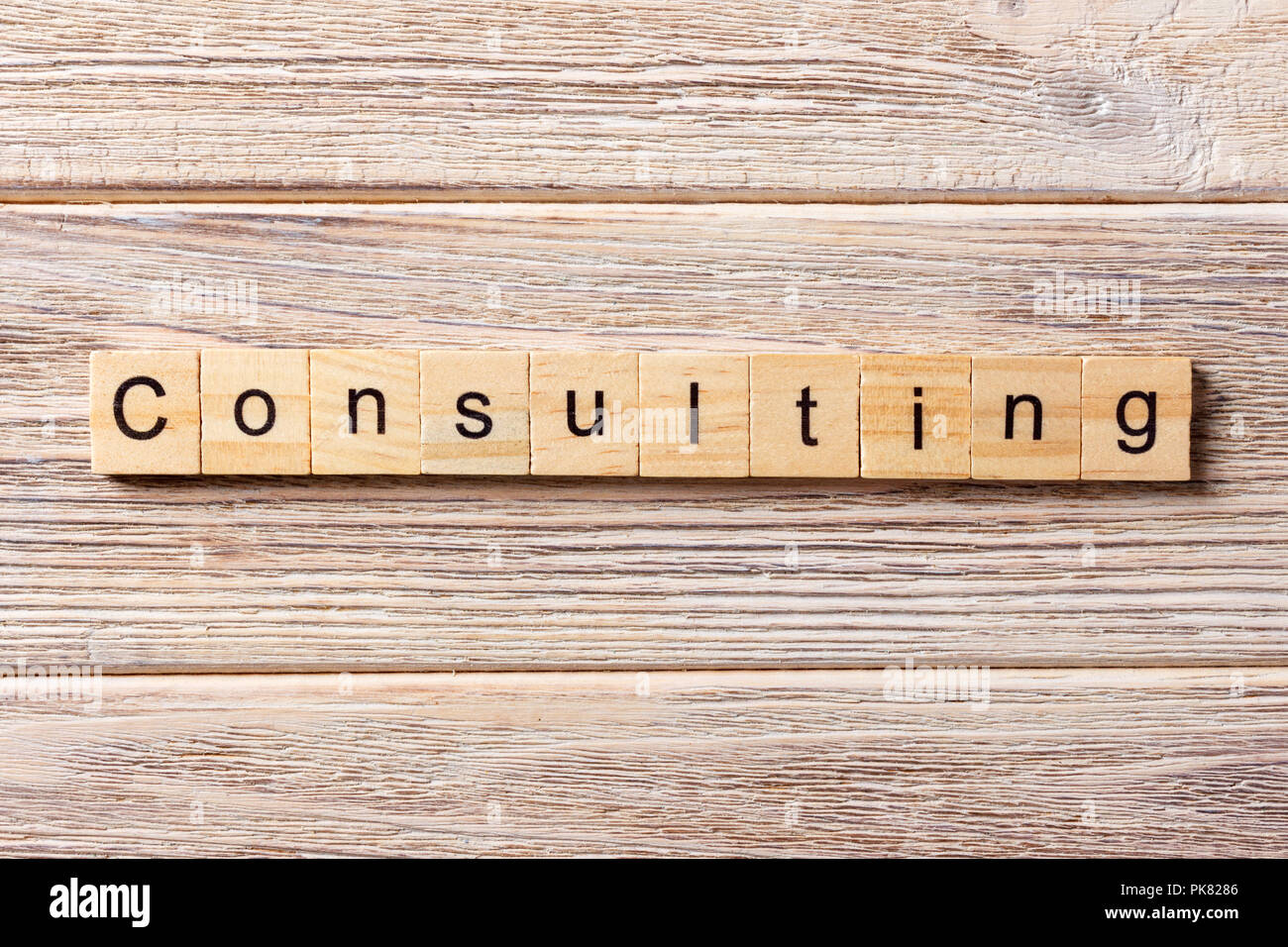 Consulting word written on wood block. Consulting text on table ...