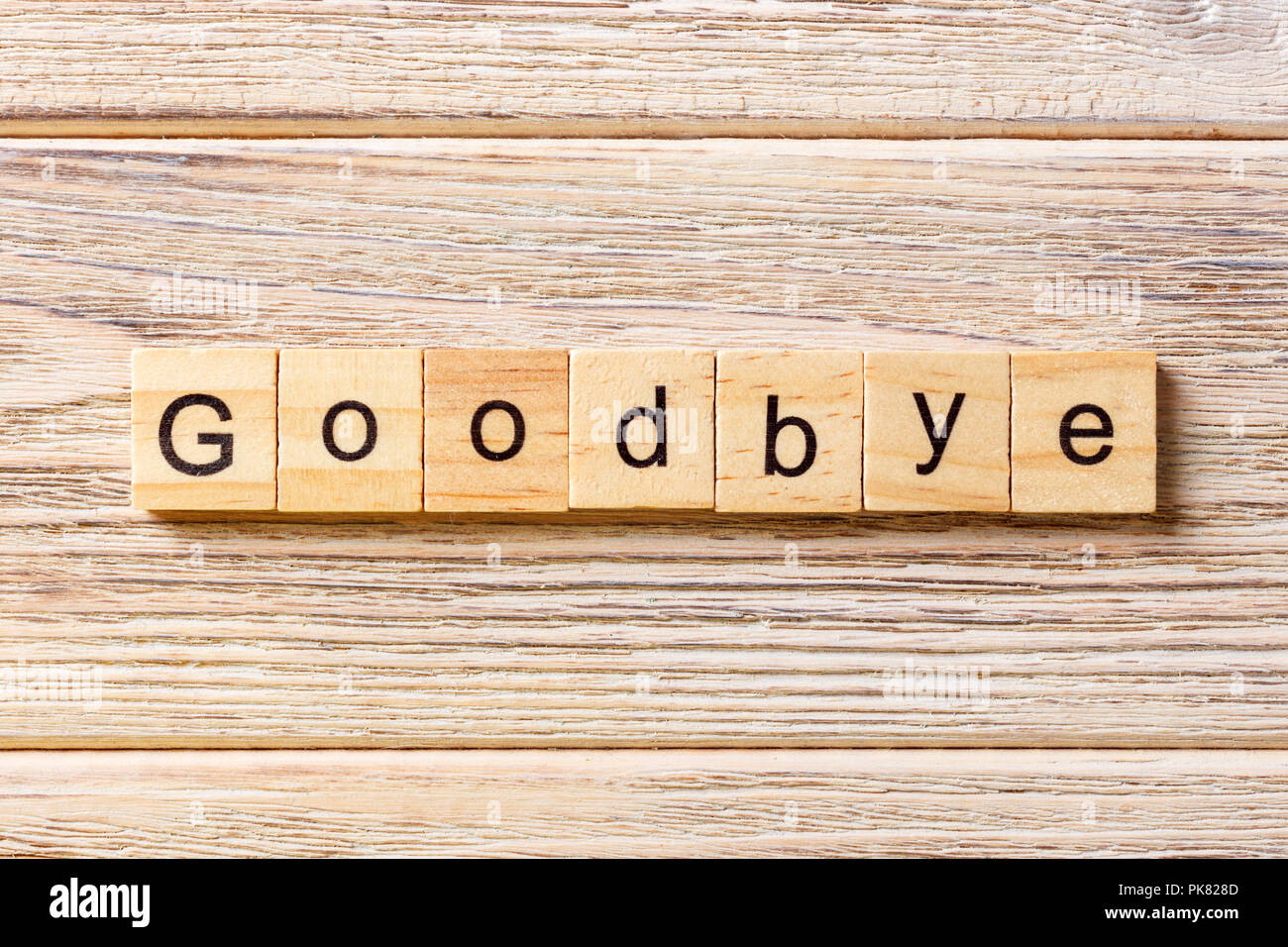 Goodbye word written on wood block. Goodbye text on table, concept ...