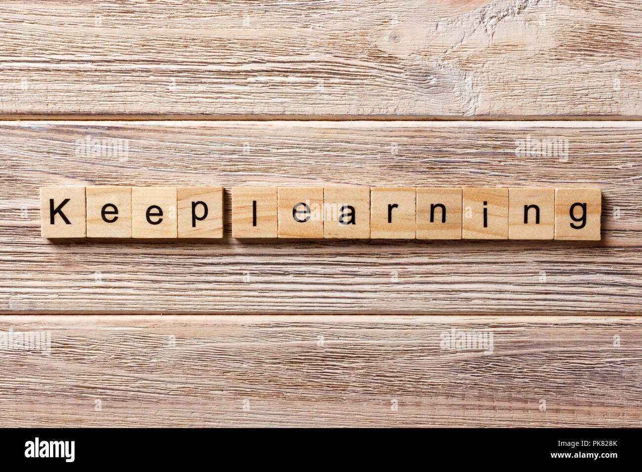 keep learning word written on wood block. keep learning text on table ...