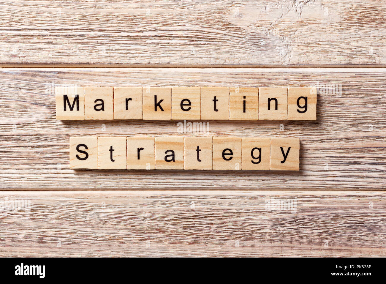 MARKETING STRATEGY word written on wood block. MARKETING STRATEGY text ...