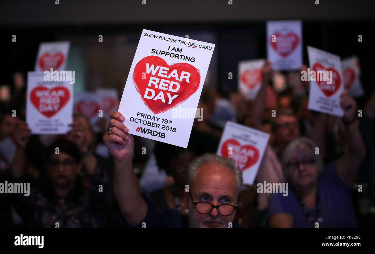 Delegates hold up a red cards to show racism the red card at the TUC ...