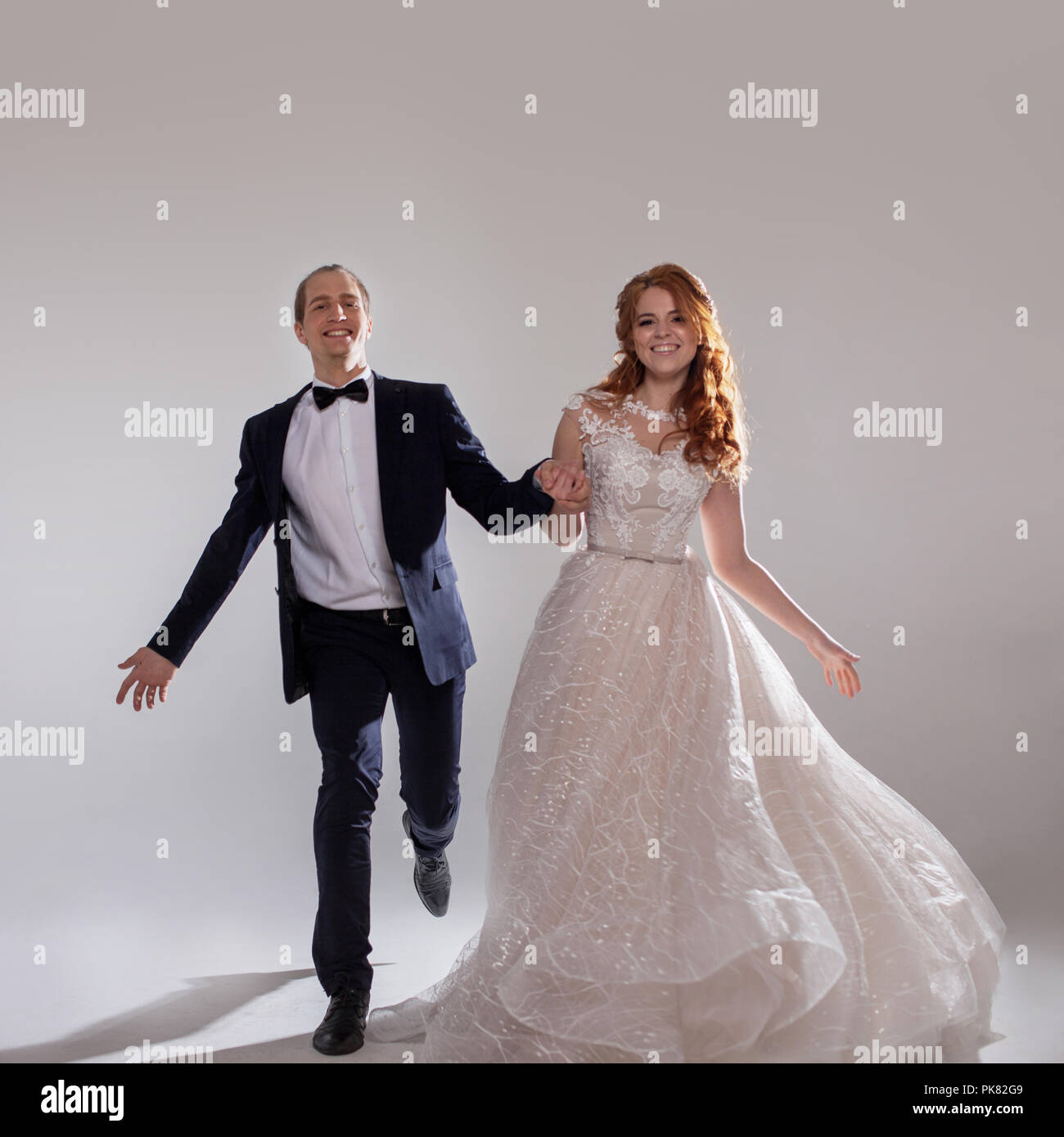 Funny and happy bride and groom, dance and jump with happiness, married ...