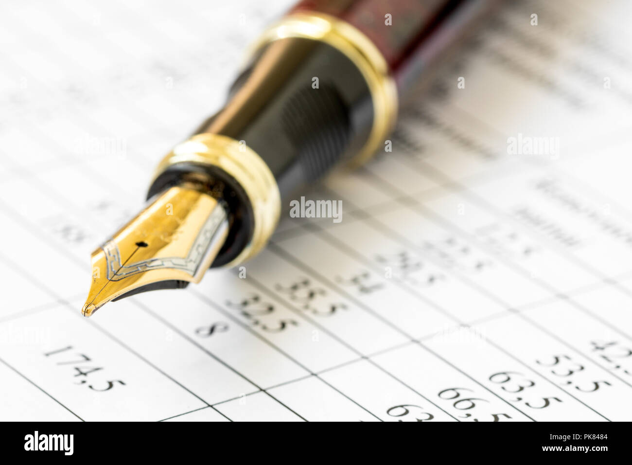 Fountain-pen on a report with many digits. Close-up view Stock Photo ...