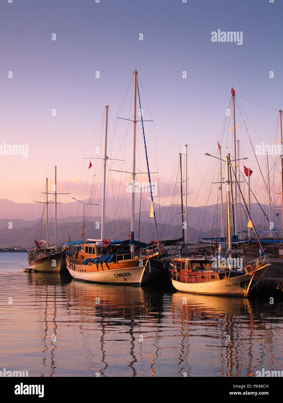 Sunset in Fethiye with traditional pretty tourist gulet boats anchored ...