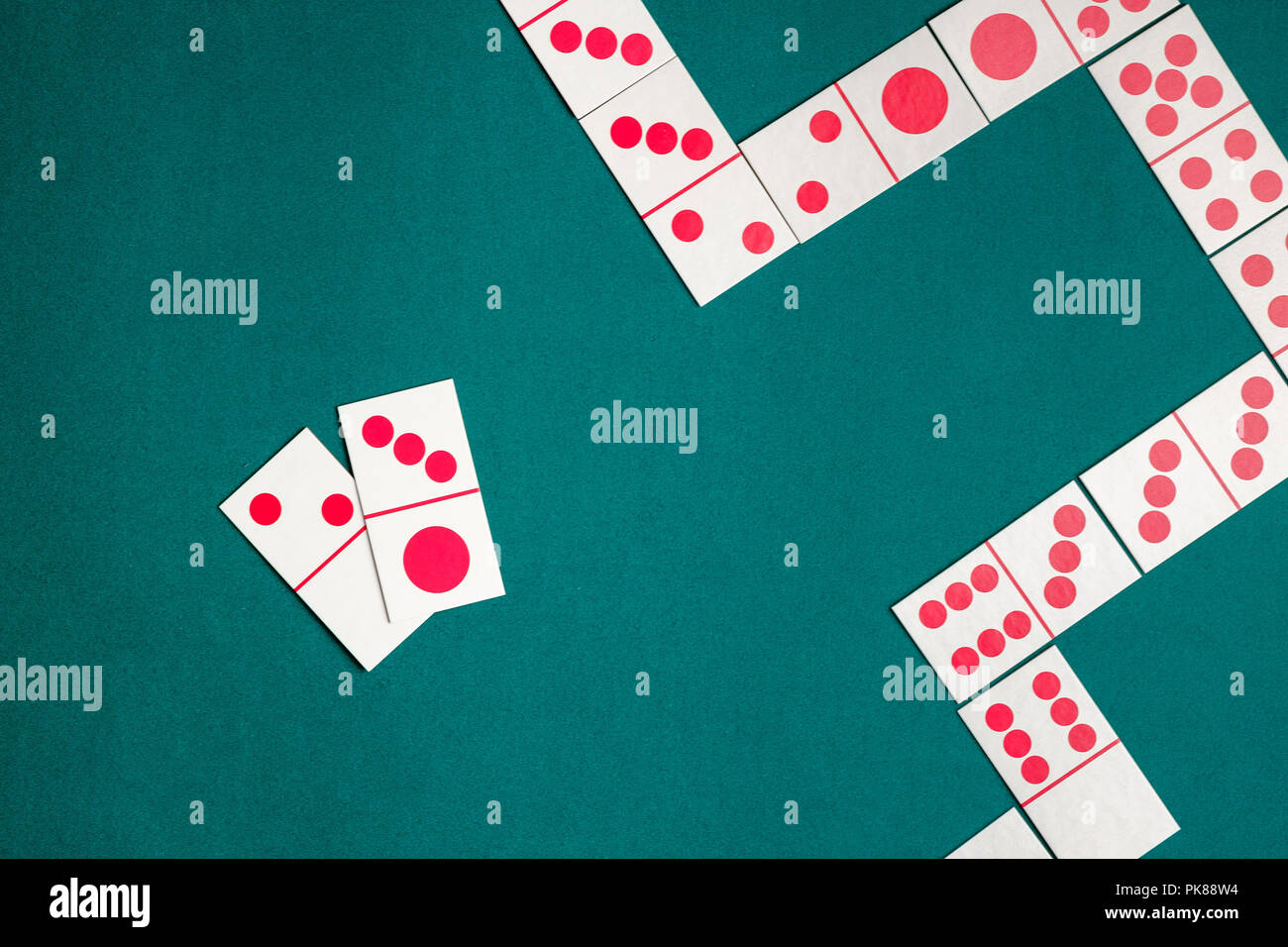 Dominoes playing card on green color table Stock Photo - Alamy