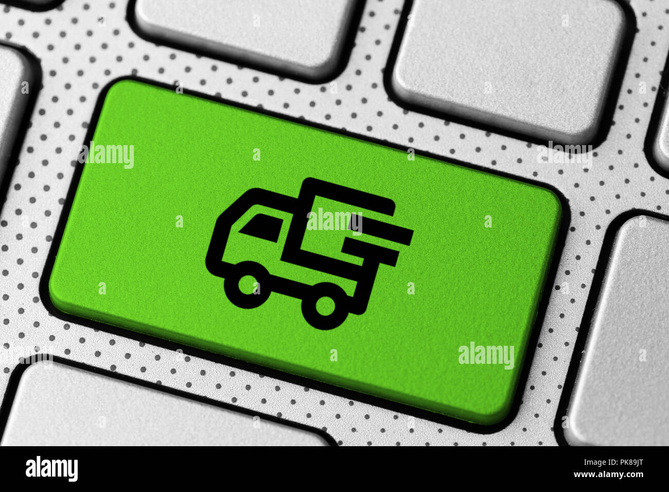 online shopping and delivery concept. laptop keyboard button with truck ...