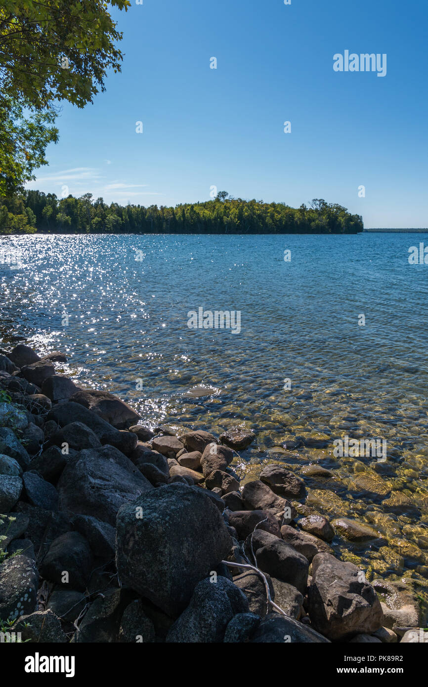 Lake Manitou shoreline landscape with cedar trees and rocks on ...