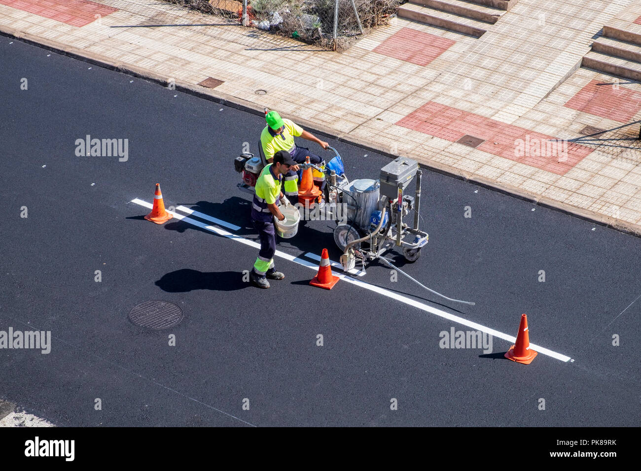 Painting new road markings on a newly resurfaced road Stock Photo - Alamy