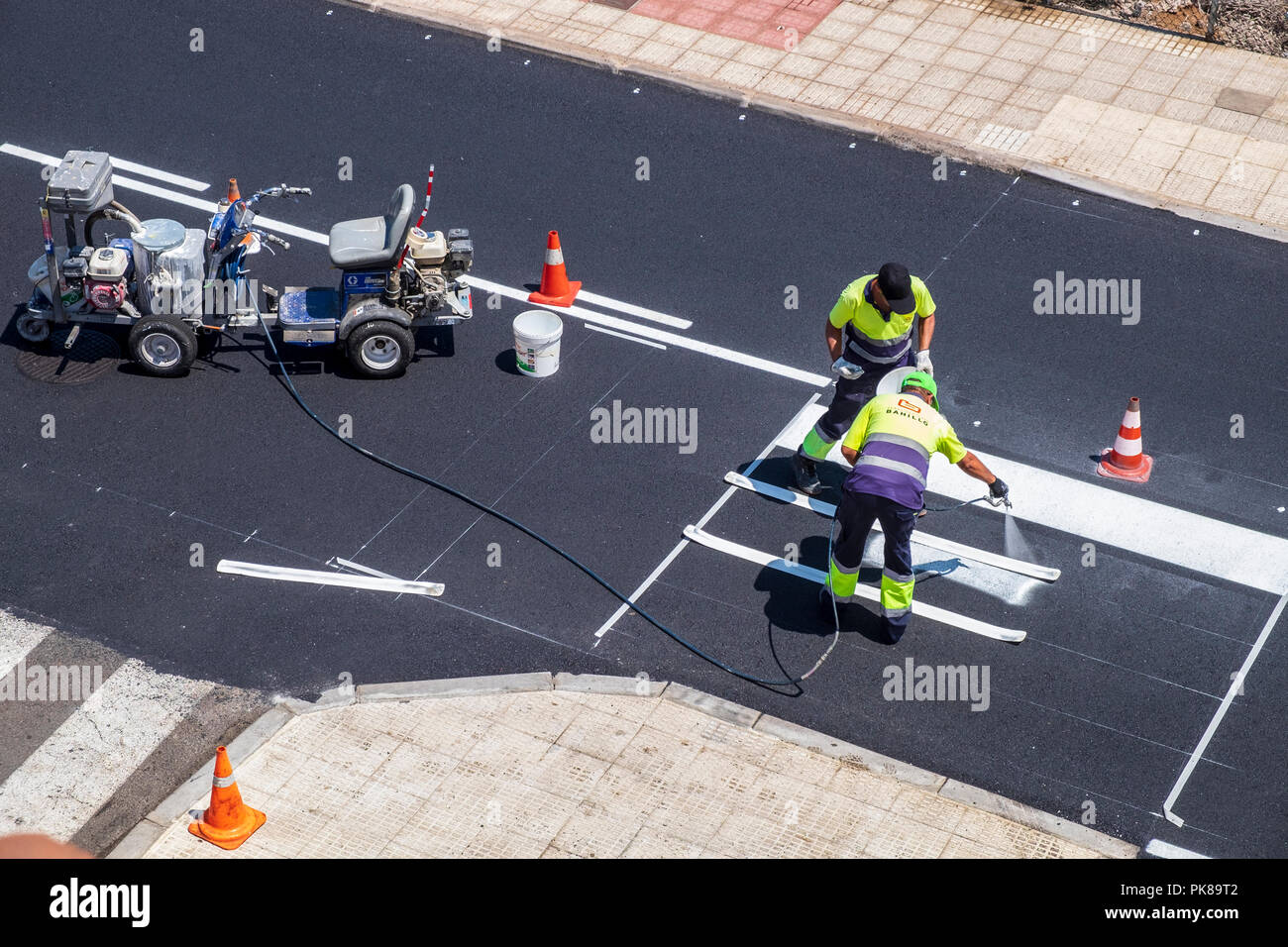 Painting new road markings on a newly resurfaced road Stock Photo - Alamy