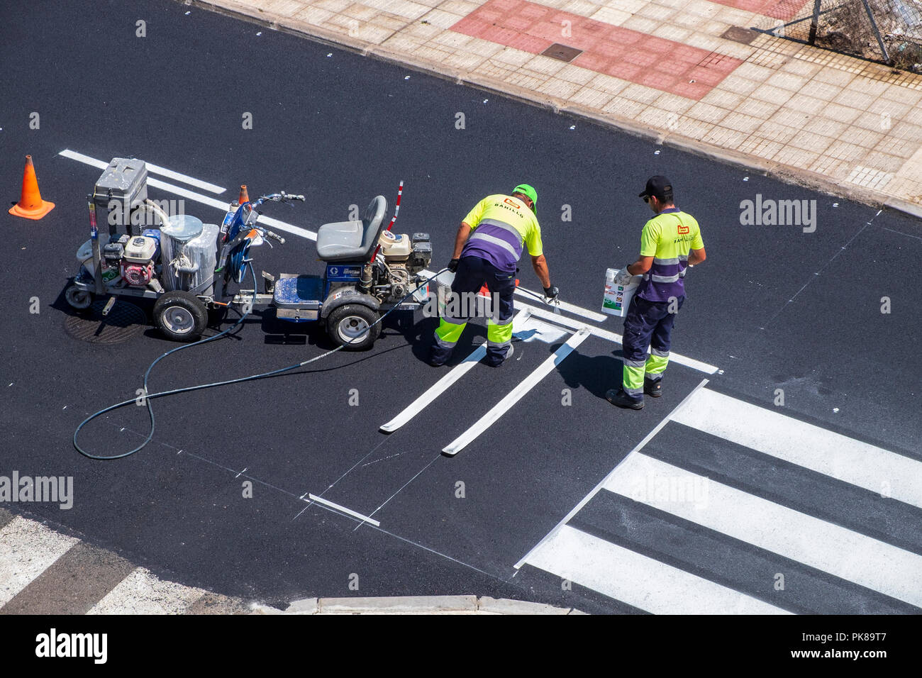 Painting new road markings on a newly resurfaced road Stock Photo - Alamy