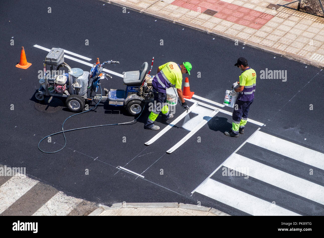 Painting new road markings on a newly resurfaced road Stock Photo - Alamy