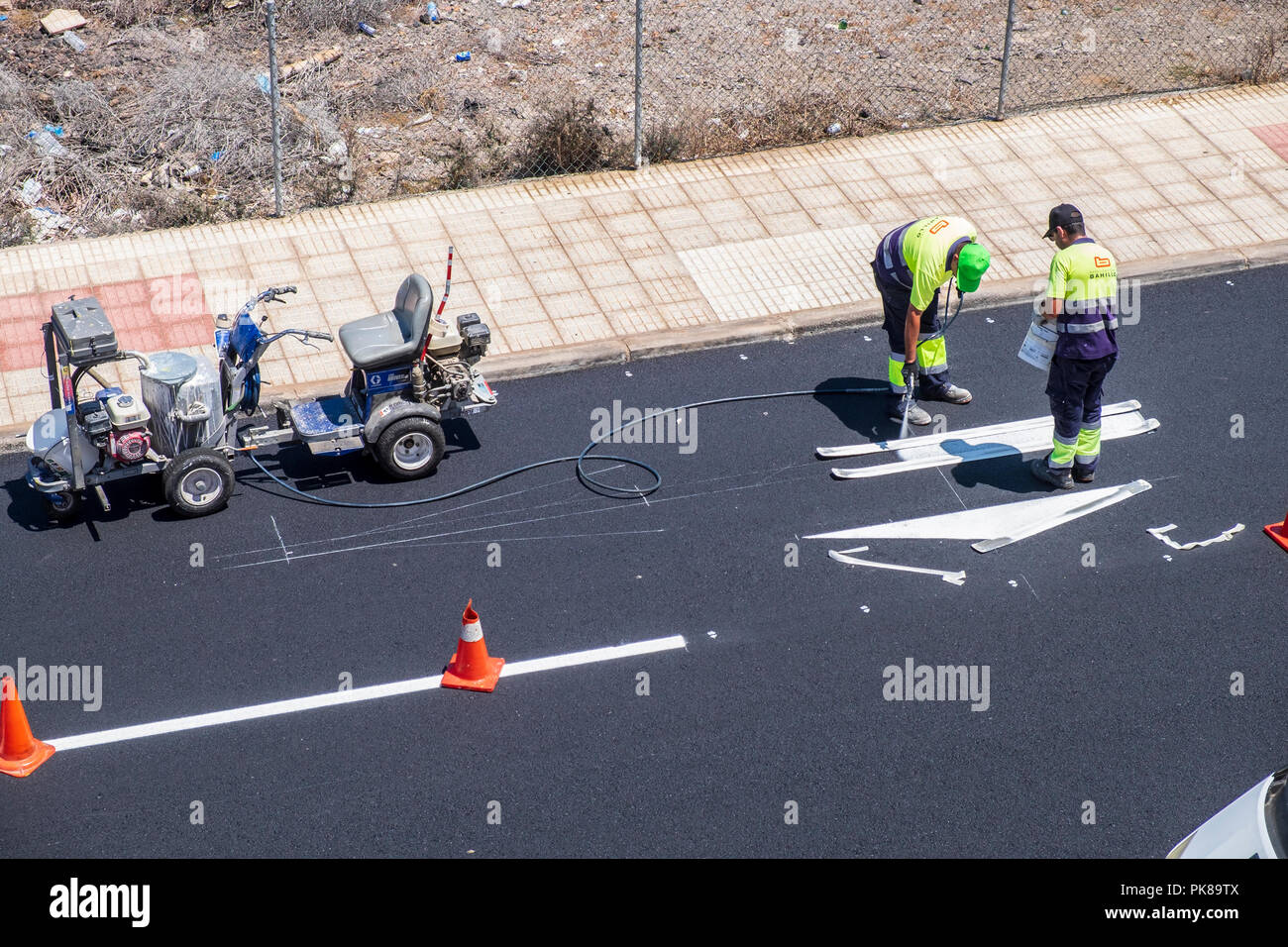 Painting new road markings on a newly resurfaced road Stock Photo - Alamy
