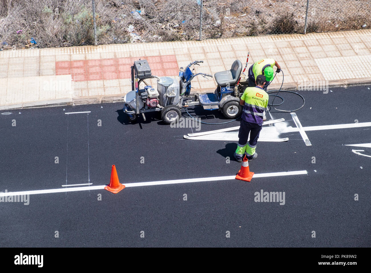 Painting new road markings on a newly resurfaced road Stock Photo - Alamy