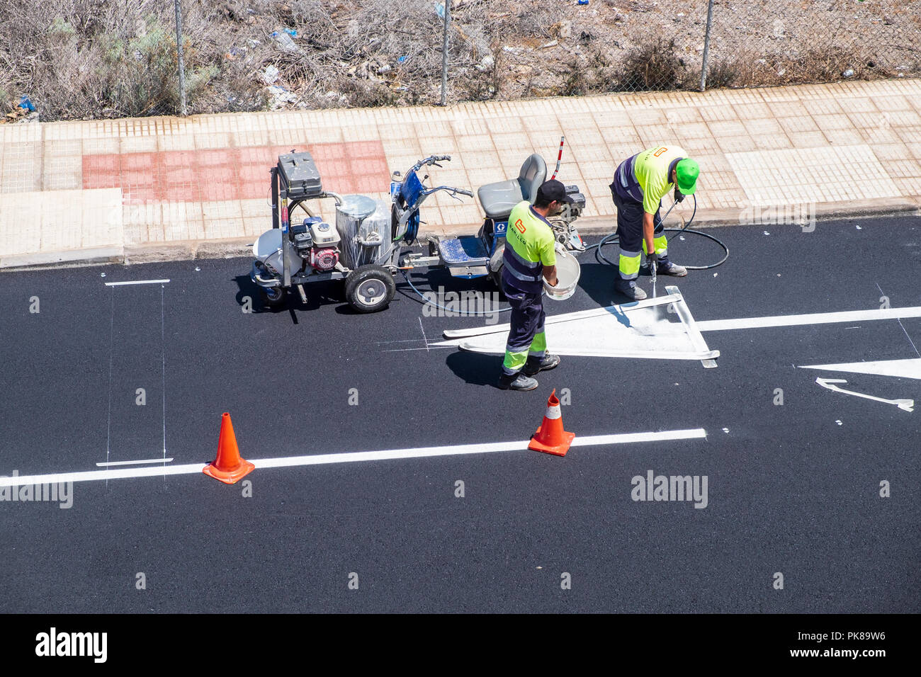 Painting new road markings on a newly resurfaced road Stock Photo - Alamy