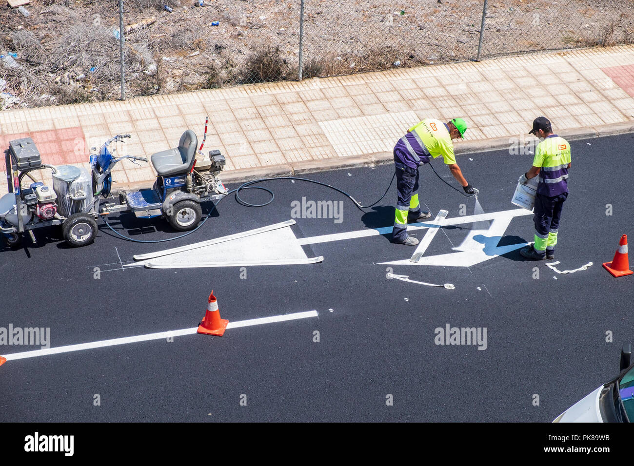 Painting new road markings on a newly resurfaced road Stock Photo - Alamy