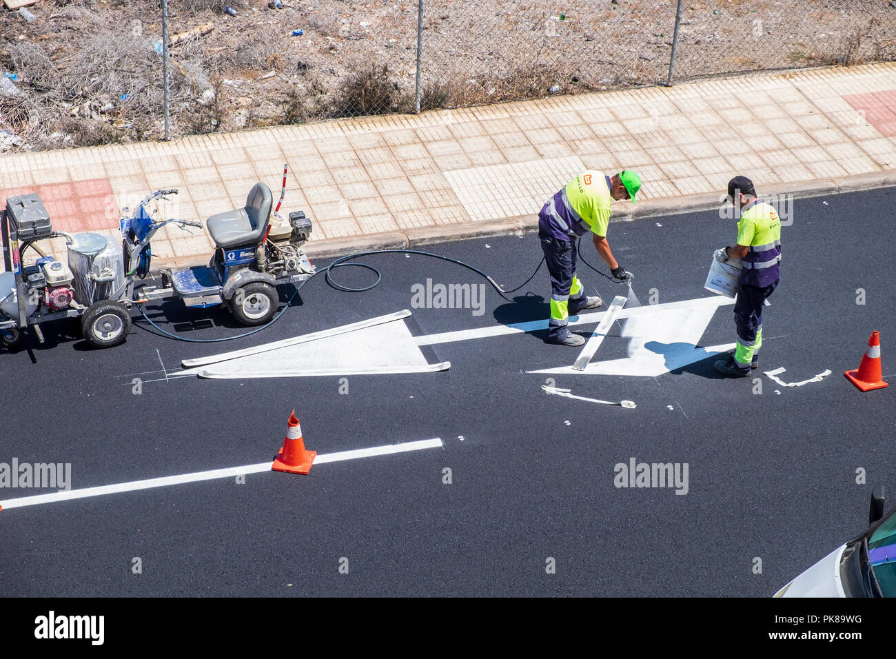Painting new road markings on a newly resurfaced road Stock Photo - Alamy